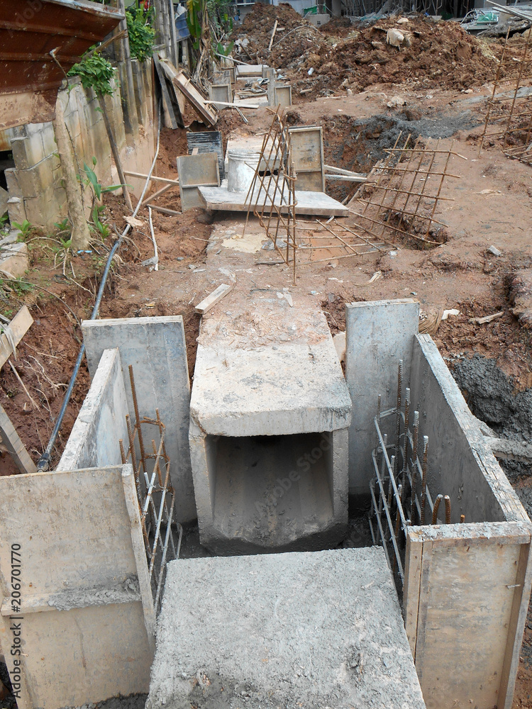 Underground drainage manhole under construction by construction workers ...
