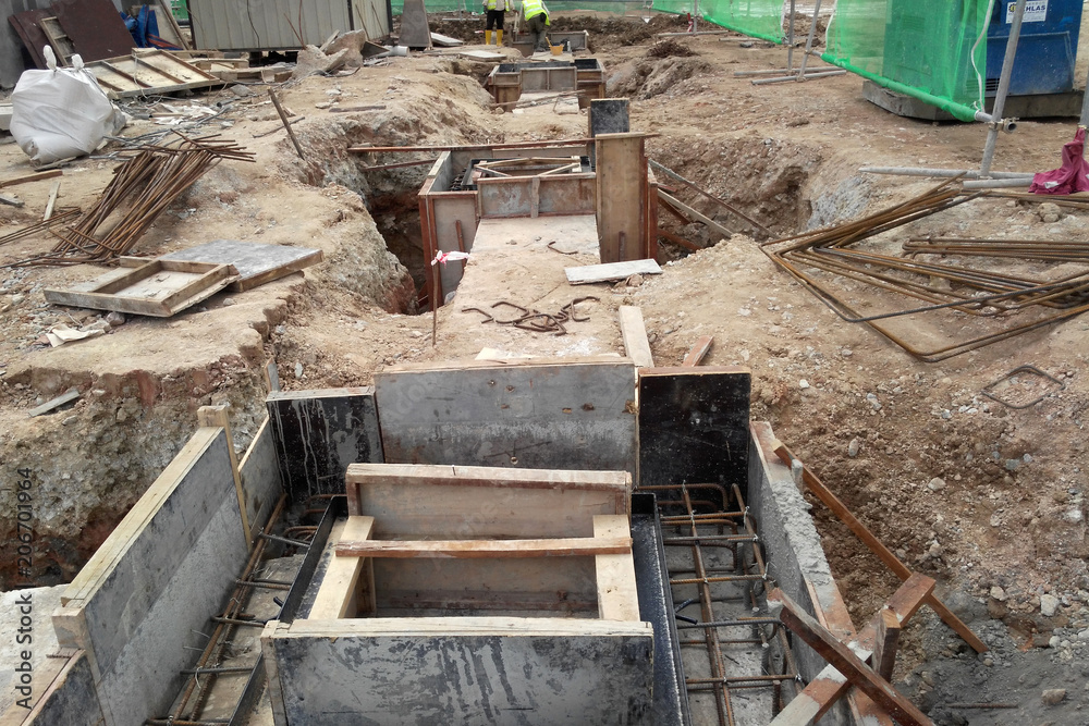 Underground drainage manhole under construction by construction workers ...