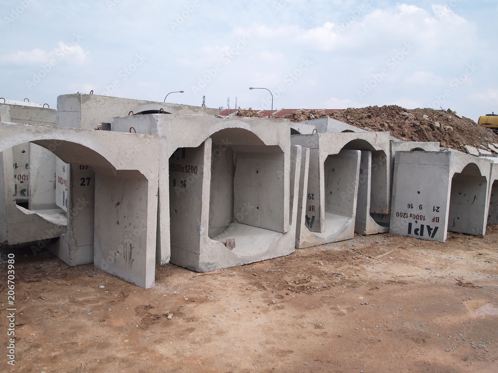 Precast concrete u-shape drain stock stacked at the construction site ...