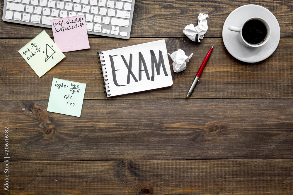 Preparing for the exam. Word Exam written in notebook on student's desk ...