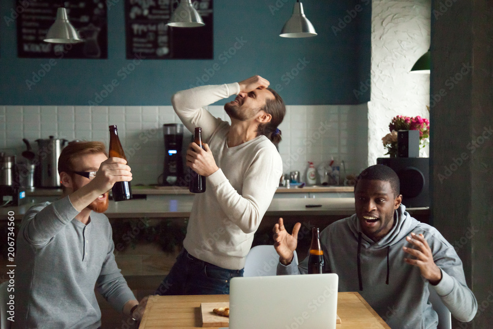 Disappointed diverse men shocked by team losing match watching game on ...