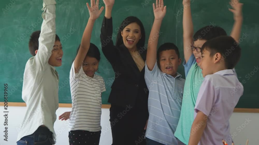 Group of asian students and teacher putting hands together and cheering ...