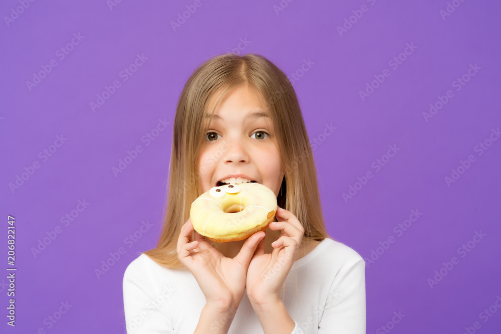 Sweetie beauty. Little girl eat donut on violet background. Child with ...