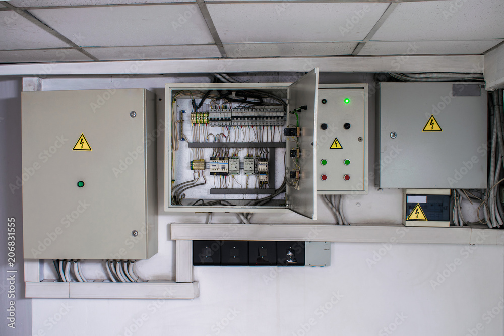 Several electrical boxes on the control panel of power supply. An open ...
