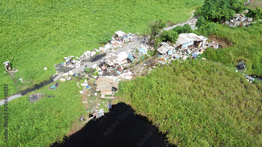 Pollution and poverty. Garbage trash pollutes poor shanty town in ...