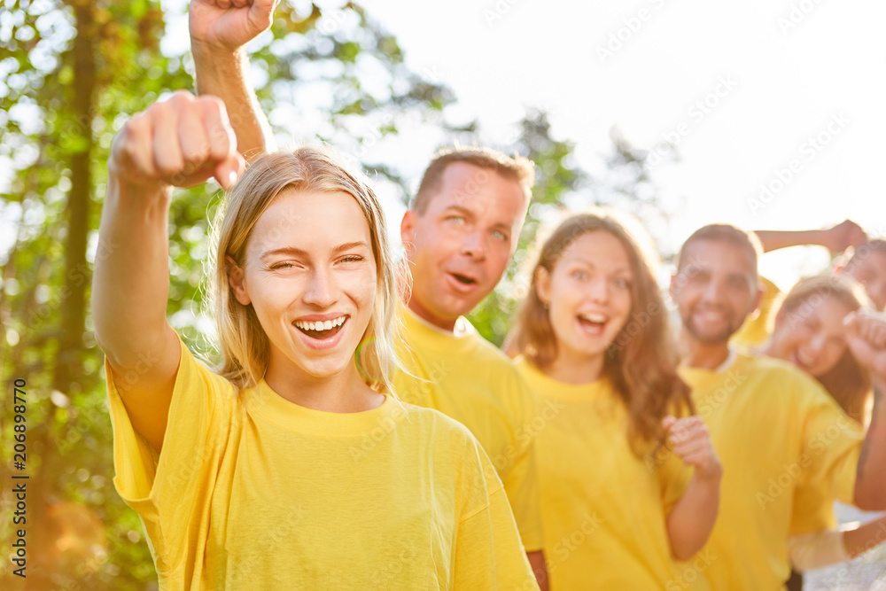 Junge Frau jubelt und freut sich im Team Stock Photo | Adobe Stock