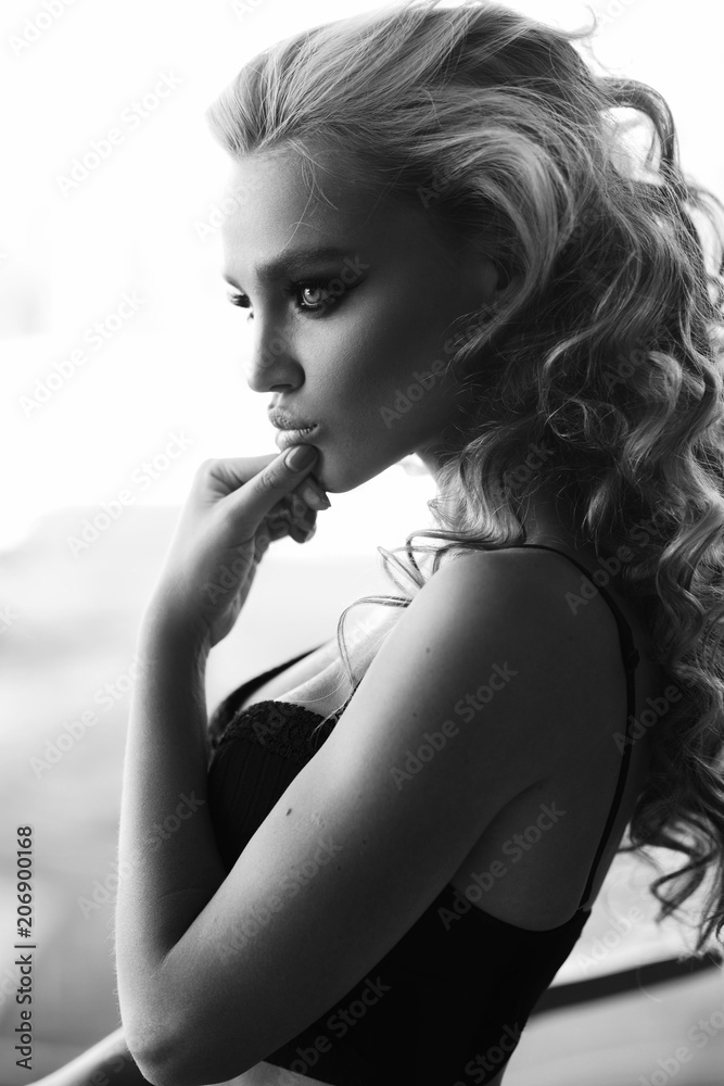 Beautiful Sexy Blonde Girl With Wet Hair Posing In A Swimsuit In The Shower Under The Drops Of