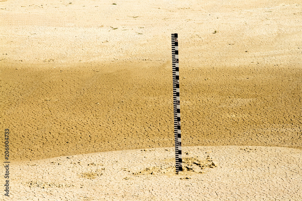 Water scale inside empty dam with mudcrack Stock Photo | Adobe Stock
