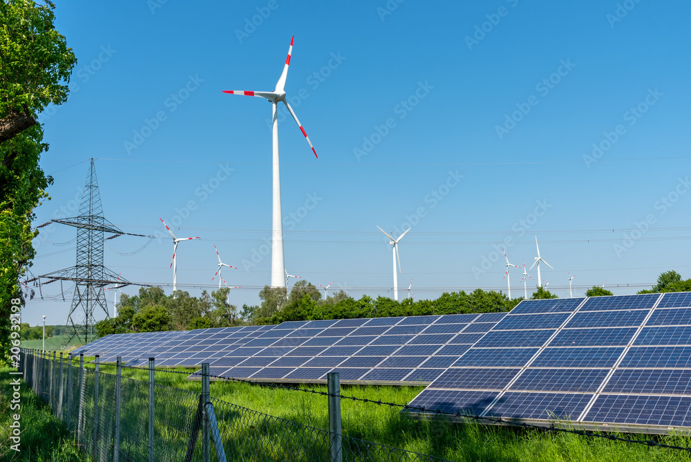 Solar panels, wind engines and an electricity pylon seen in Germany ...