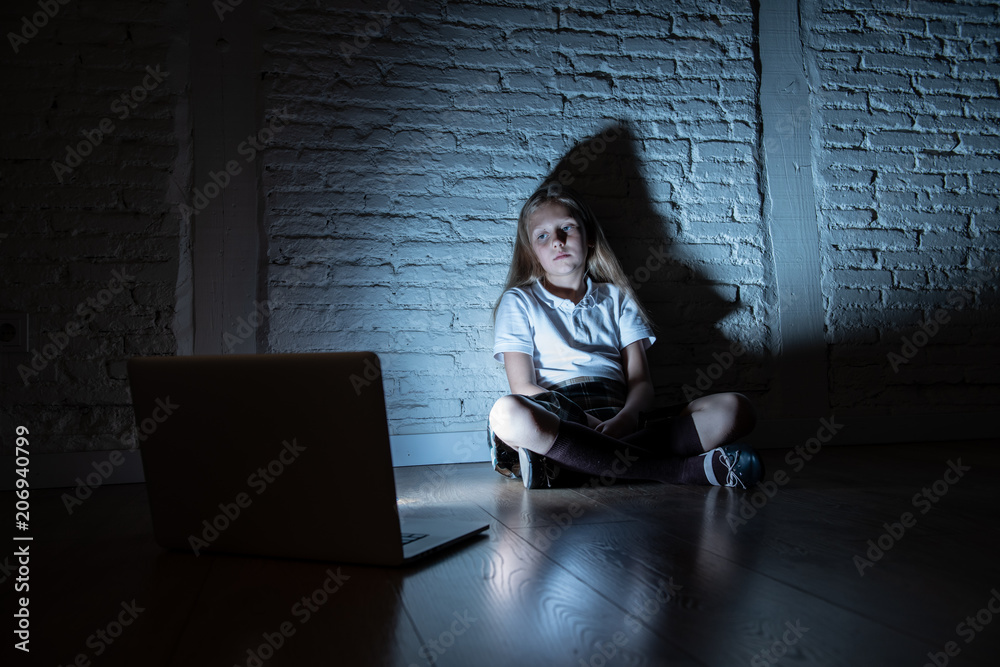 Sad young girl with laptop suffering bullying and harassment online ...