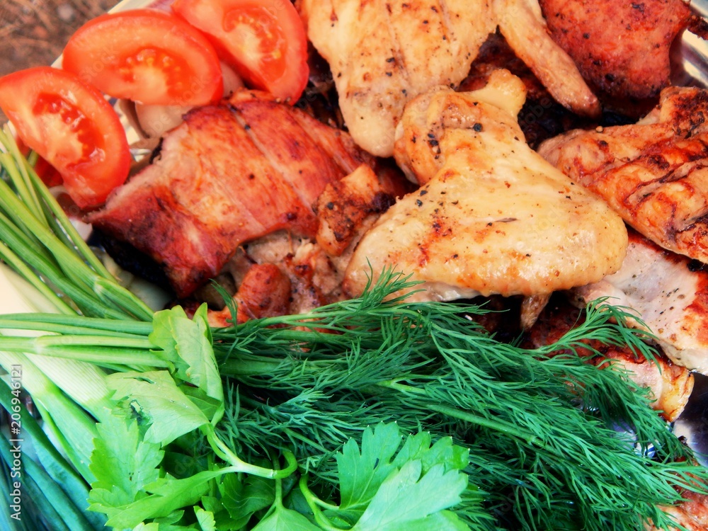 Barbecue still life. Chicken meat with greens and tomato slices close ...