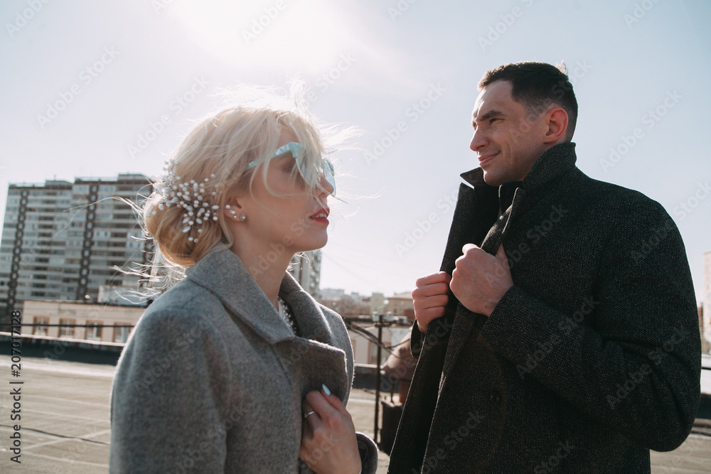 Pre-wedding shooting on the roof of the building, on the street. Happy ...