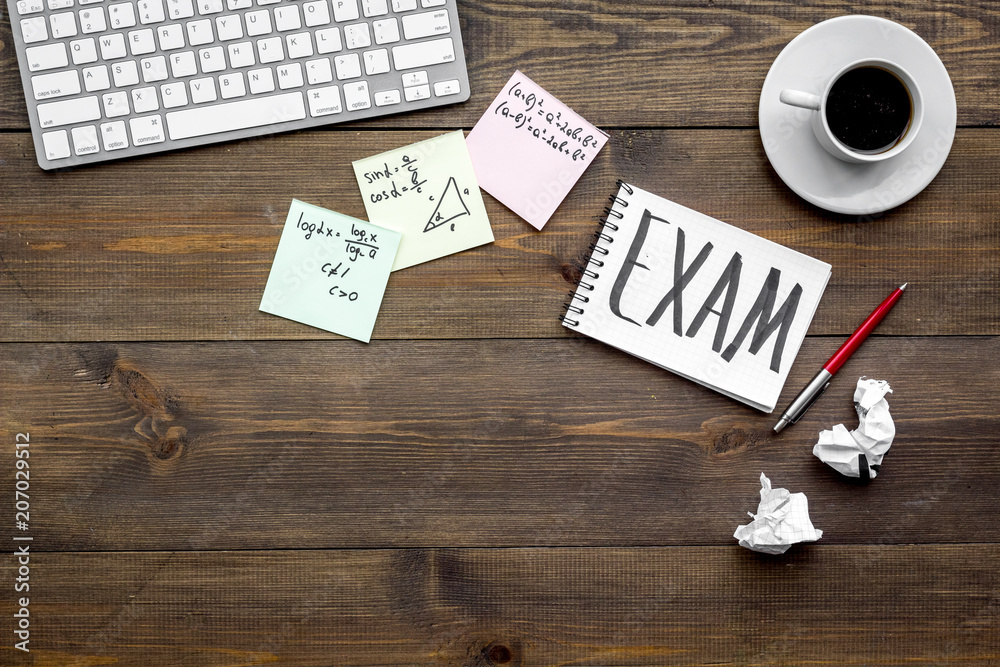 Preparing for the exam. Word Exam written in notebook on student's desk ...
