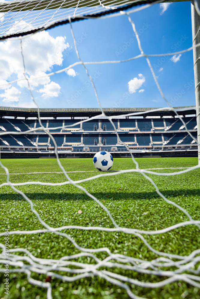 Football stadium and ball behind gates net Stock Photo | Adobe Stock