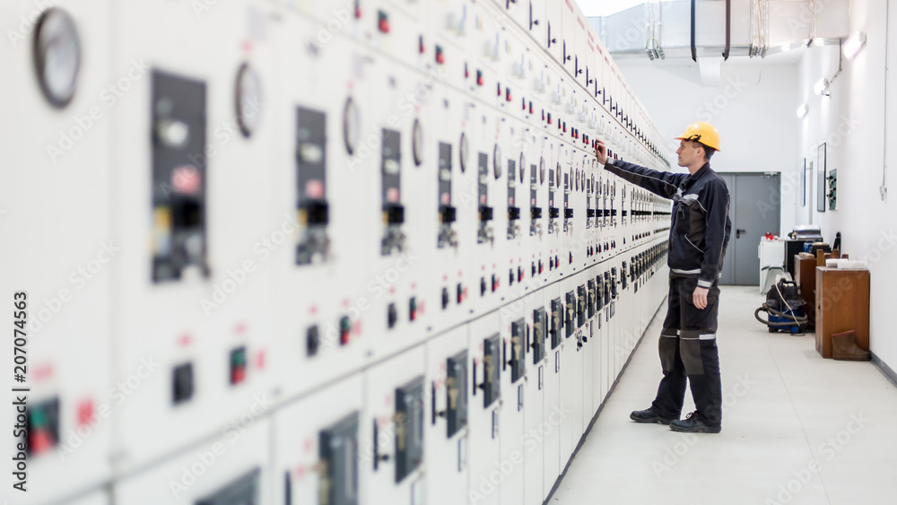 Engineer commissioning bay control unit. Engineering department Stock ...