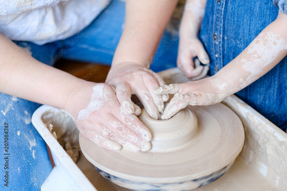pottery handcraft hobby. two pairs of hands forming and shaping a ball ...