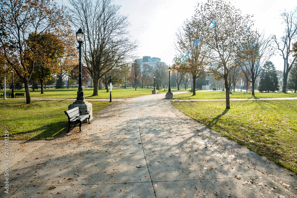 Empty Path Lined with Benches and Street Lights in a Downtown Park on a ...
