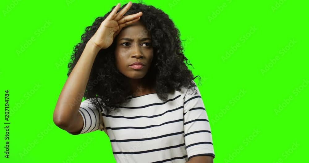 Pretty African American young woman putting her hand to the forehead ...