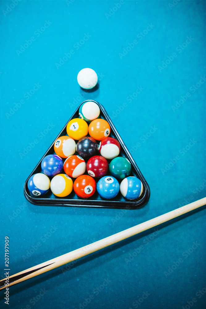 Pool table with cue and rack of balls Stock Photo | Adobe Stock