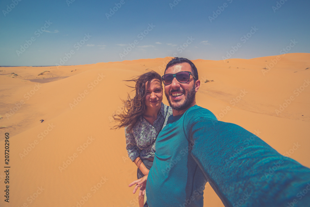 Happy tourist couple smiling take photo selfie in the Middle of the red ...