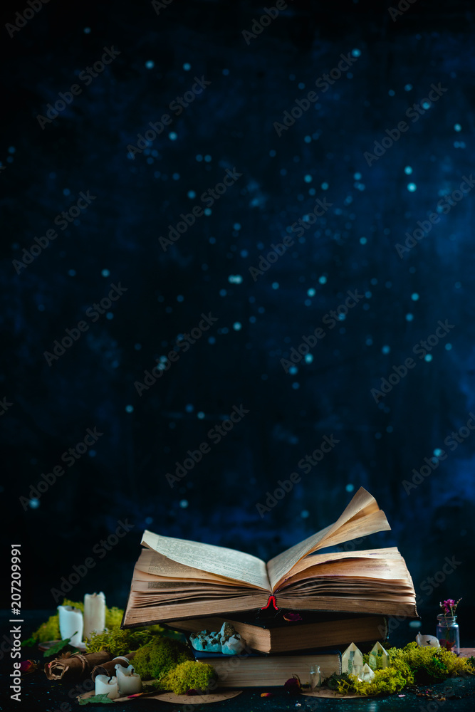 Open book with candles, crystals, and moss. Reading fantasy concept ...