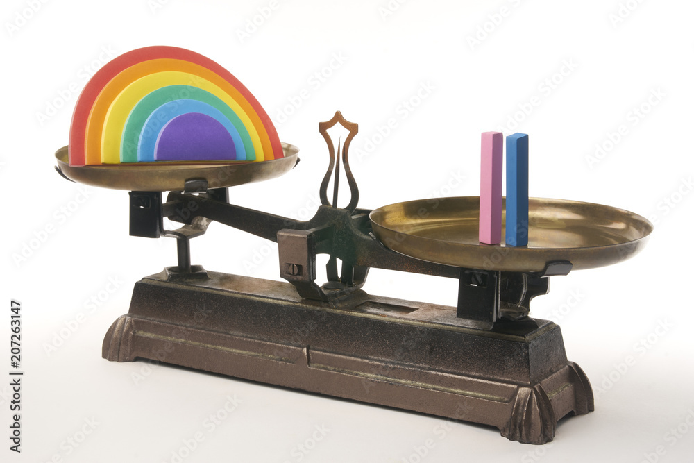 On a scales weigh a rainbow with two pink and blue sticks. LGBT concept ...