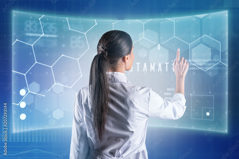 Futuristic computer. Clever progressive biologist carefully touching a ...