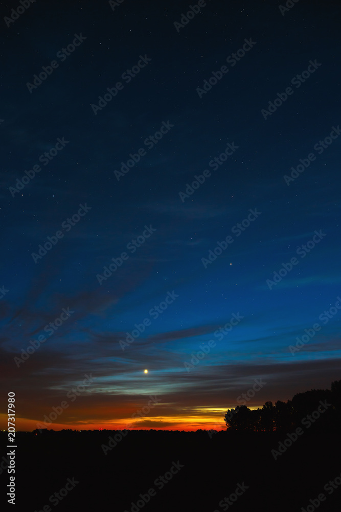 Venus in the night sky with stars. A bright sunset with clouds. Cosmic ...