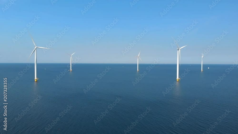 Offshore wind mill park in the ocean, windmill turbines with a blue ...