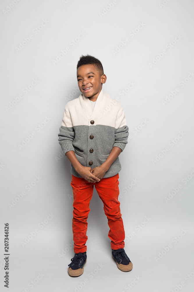 Smiling boy standing against white background Stock Photo | Adobe Stock