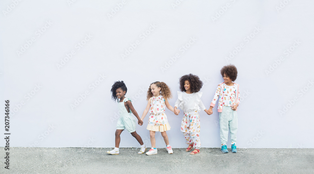 Happy children playing against wall Stock Photo | Adobe Stock