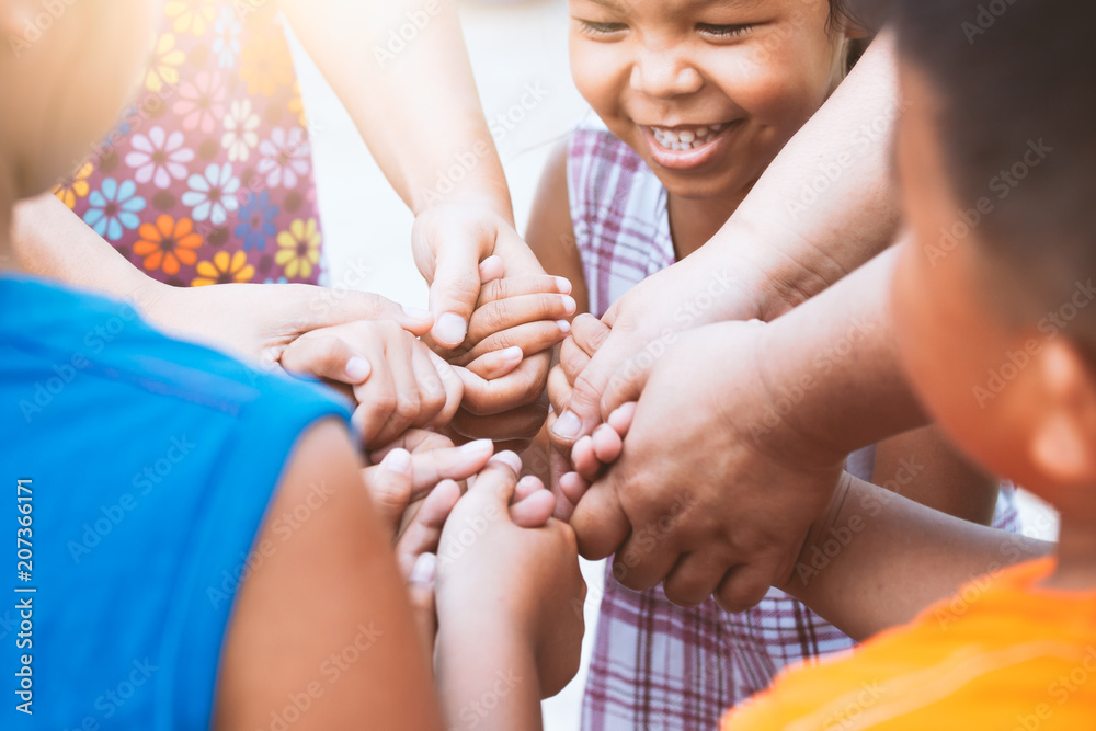 Children and parent holding hands and playing together with unity and ...