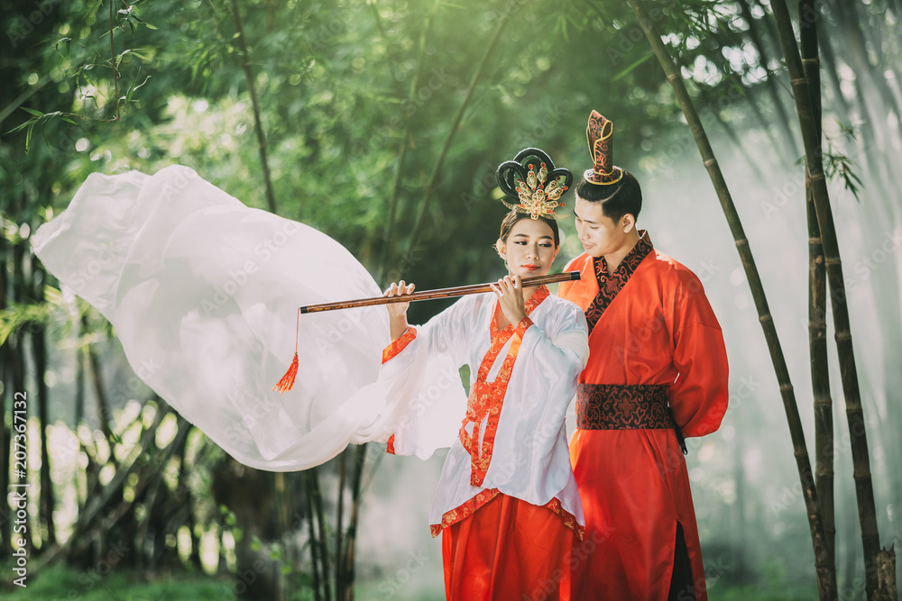 The flute girl gave the young man a listen in traditional Chinese dress ...