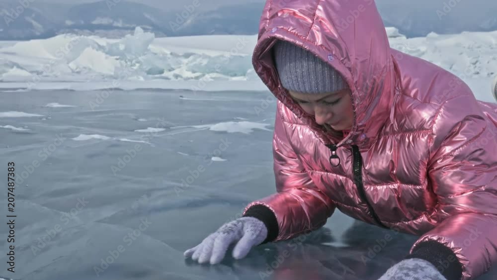 Vidéo Stock Girl walking on cracked ice of a frozen lake Baikal. Woman ...