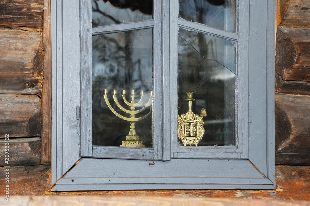 An old window with broken glass in an old wooden house. On the window ...