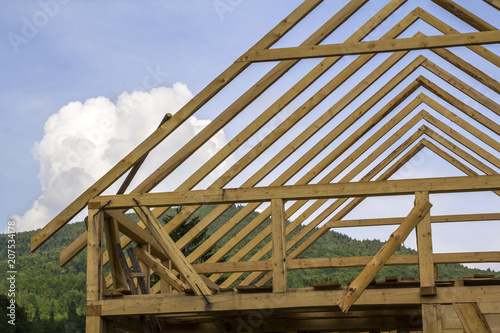 Close-up detail of wooden high steep roof framing under construction ...