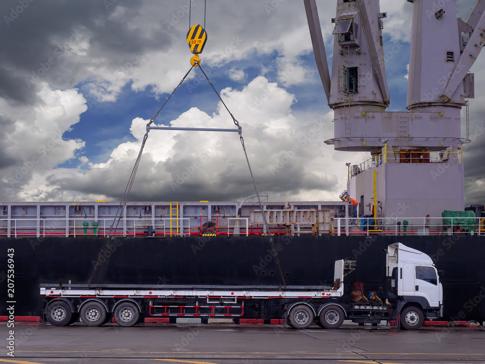 The vessel loading steel billet from truck to onboard at industrial ...