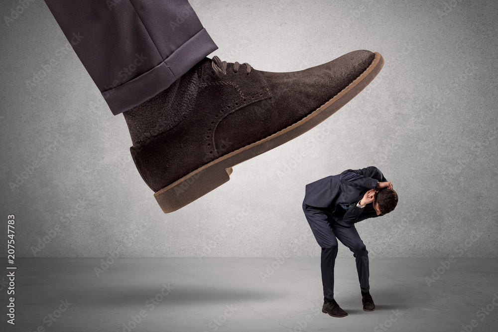 Employee is afraid of the big boss foot, which is stepping down him ...