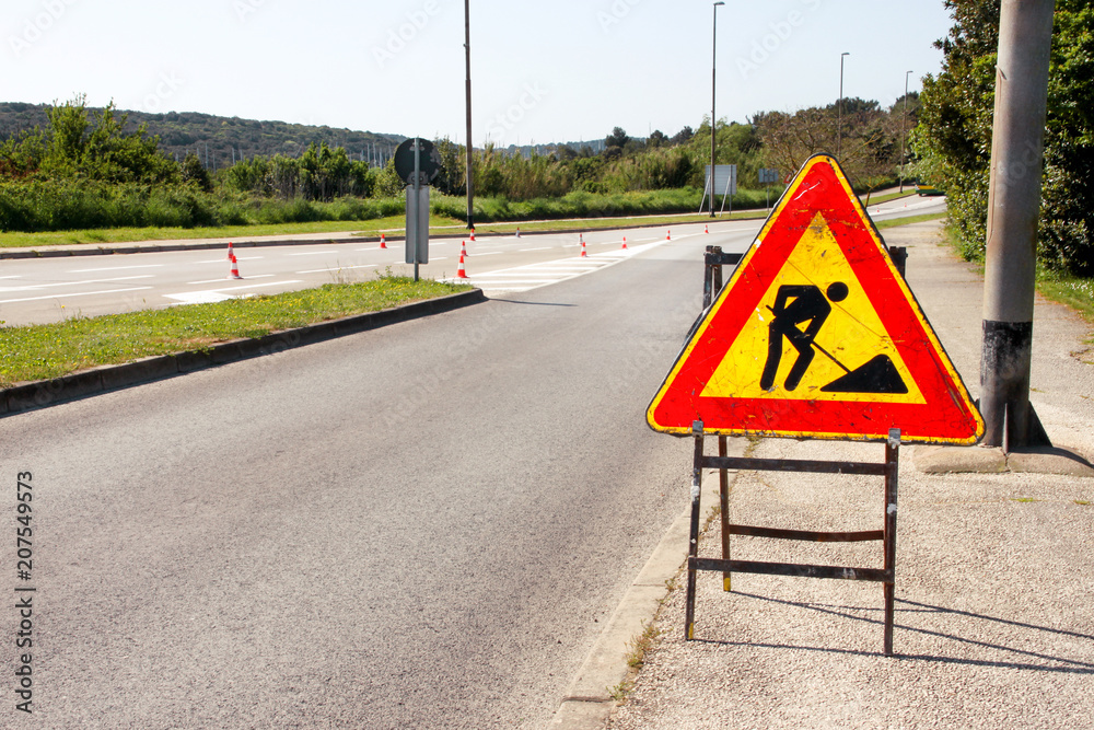 Road works sign for construction works in city street. Road under ...