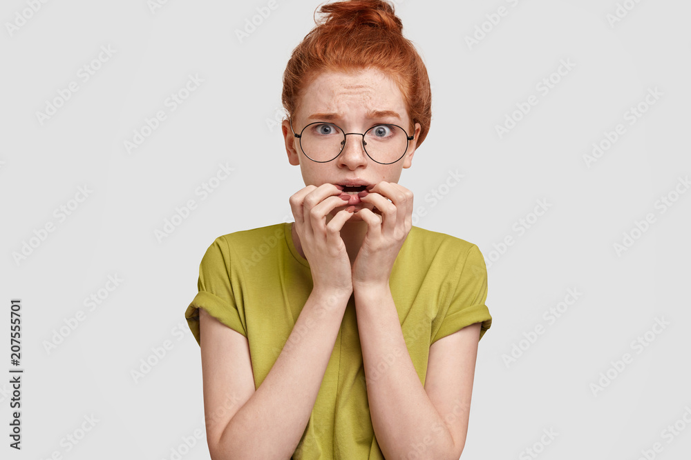Neurotic foxy female with freckled skin, looks embarrassed and scared ...