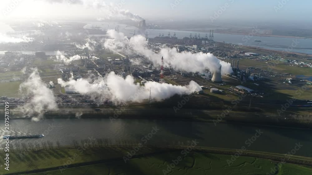 Aerial footage of nuclear power plant and cargo vessel barge moving ...