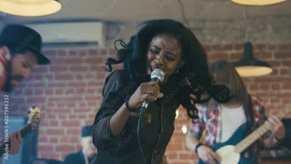 Beautiful African-American girl singing emotionally having performance ...