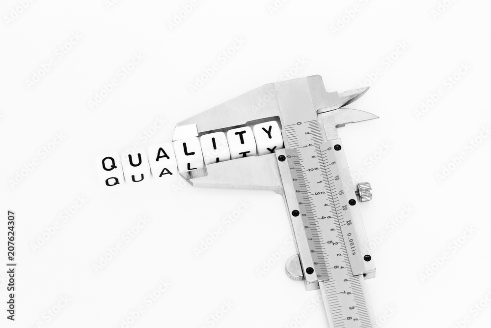 Quality symbol with alphabet cubes and caliper Stock Photo | Adobe Stock