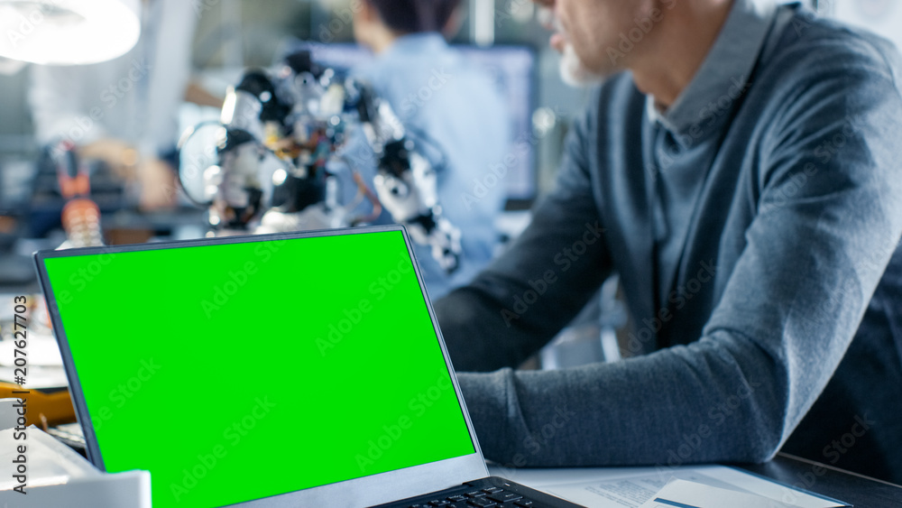 Robotics Engineer Manipulates Voice Controlled Robot, Laptop with Green ...