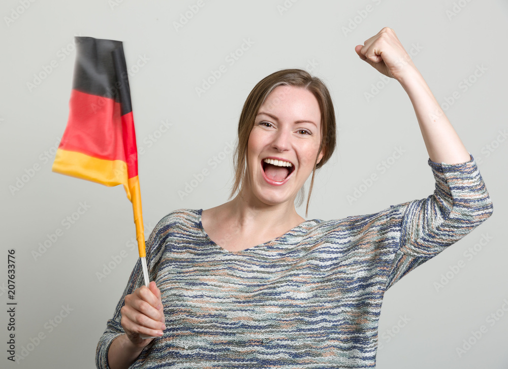Junge Frau jubelt mit einer Dutschlandfahne Stock Photo | Adobe Stock