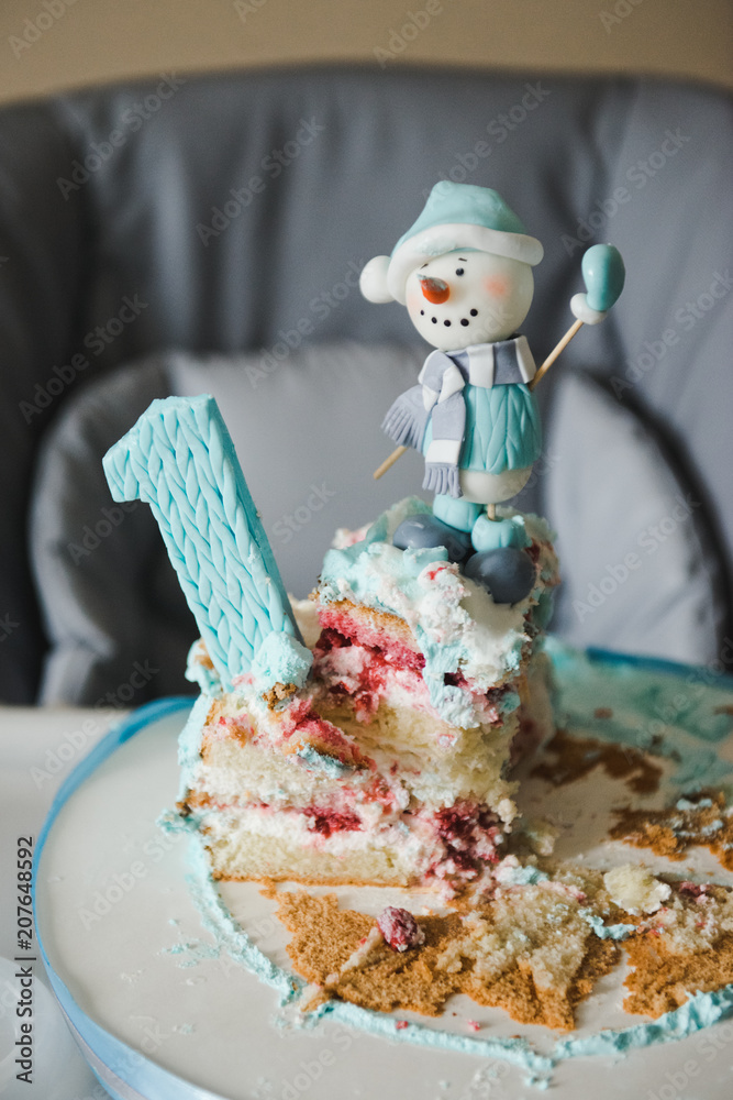 Broken child cake. Kid's feet near the cake. Cute little boy eating his ...