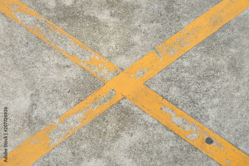 Surface of yellow cross the line on the concrete street/road ...