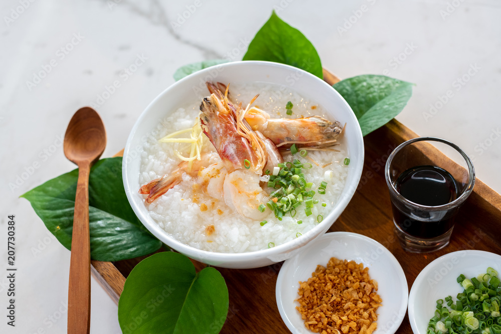 Beautiful presentation of Asian breakfast, congee with shrimp in wooden ...
