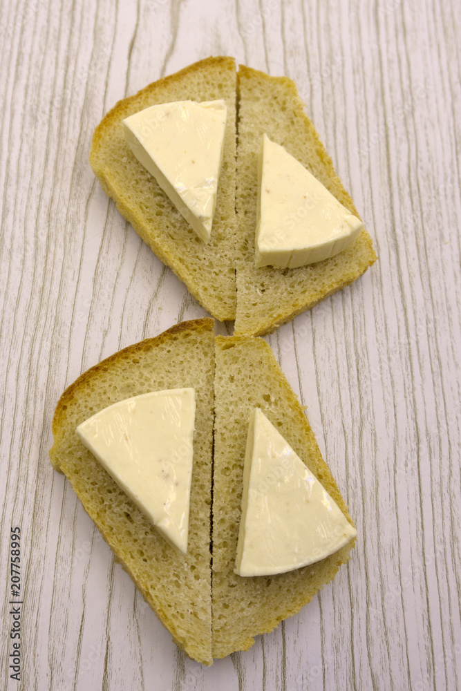 table of cut with wedge of cheese cut partially sliced . Stock Photo ...