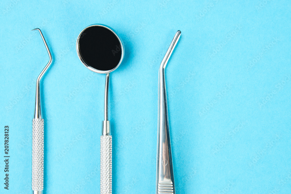 Foto de Professional Dentist tools on blue background with copy space ...